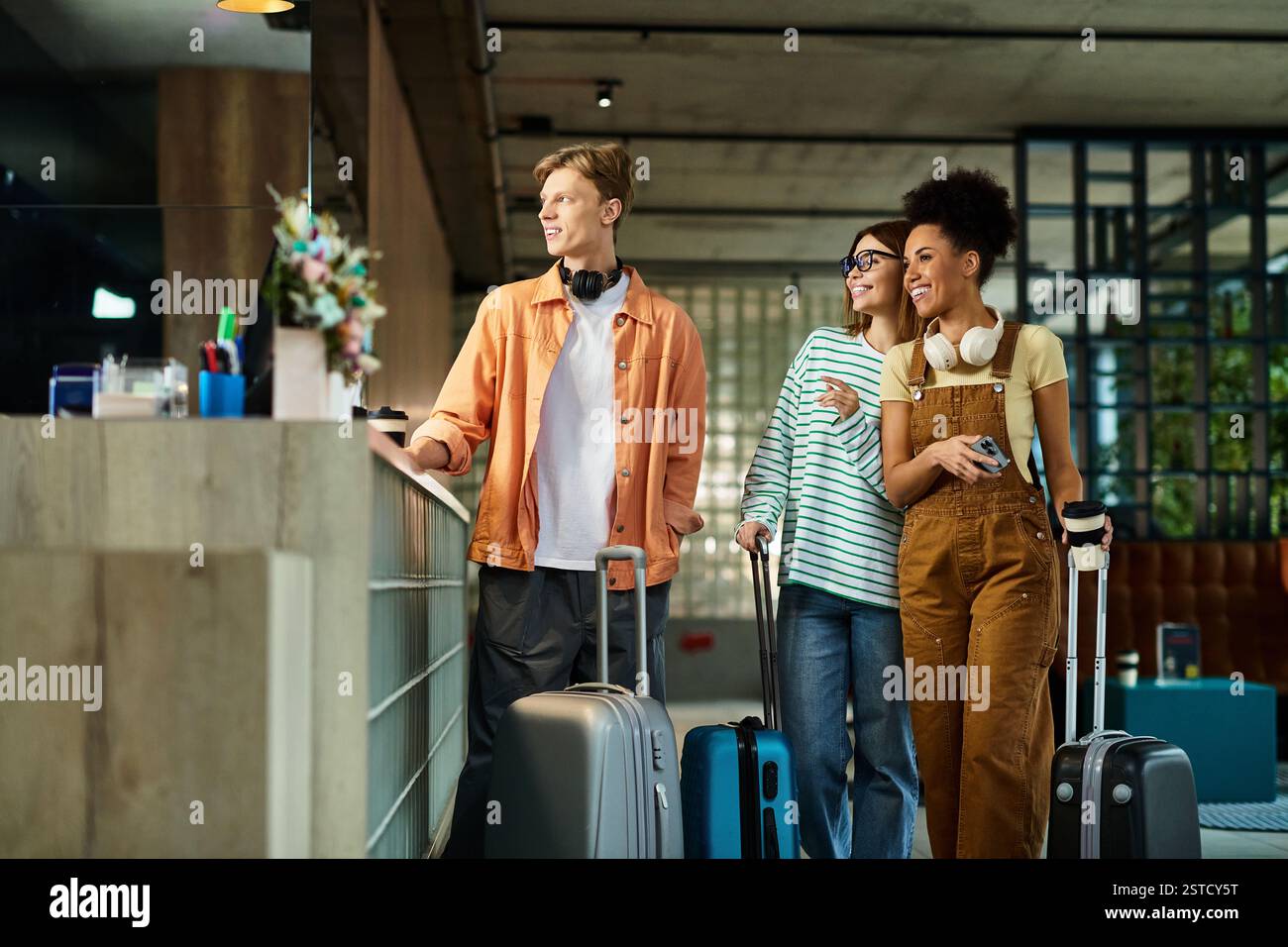 Three colleagues smile and chat while checking in at a contemporary ...
