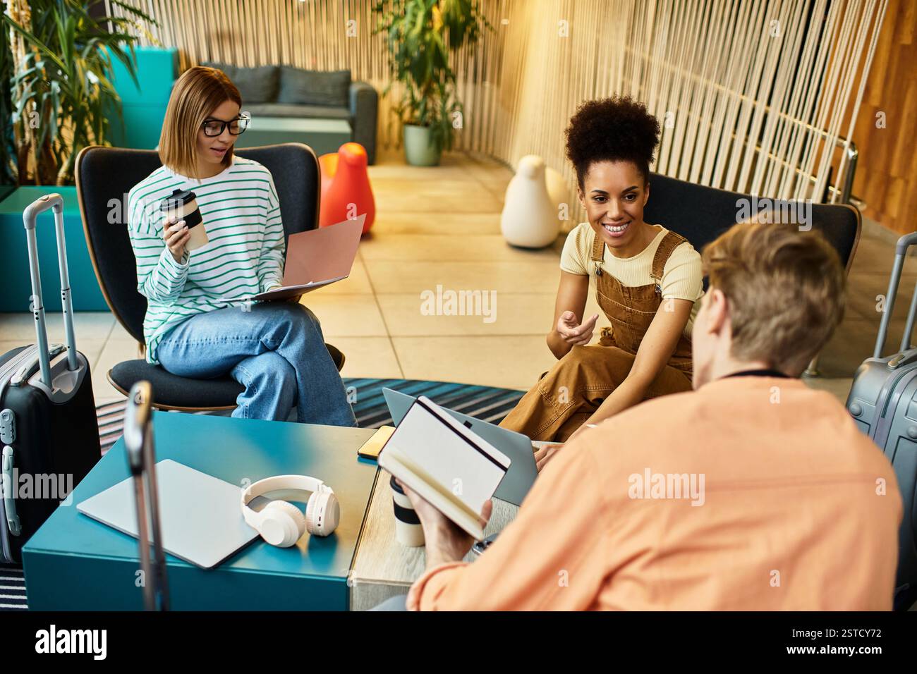 Three colleagues engage in a lively discussion while working in a ...