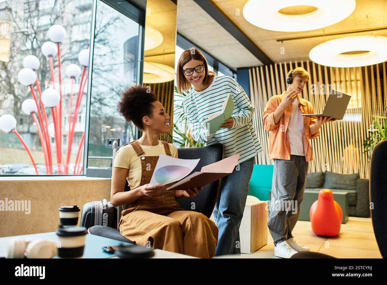 Three colleagues engage in a productive meeting at a hotel lounge ...