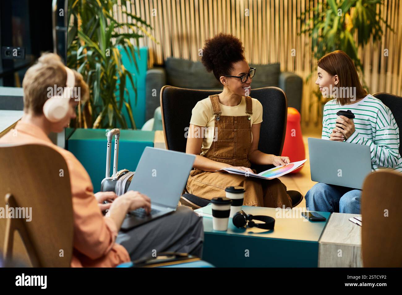 Colleagues engage in a lively discussion and brainstorming session in a hotel lounge area Stock ...