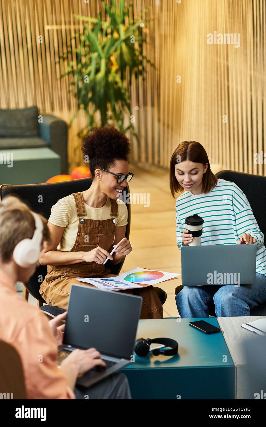 A group of colleagues collaborates on creative projects while enjoying ...