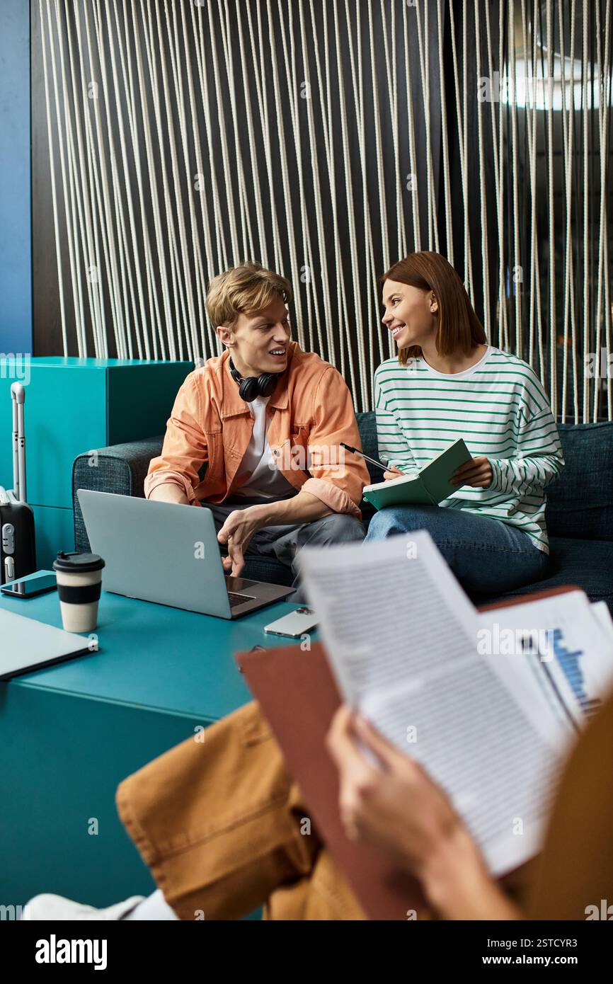 Two colleagues engage in a lively discussion while working on their ...