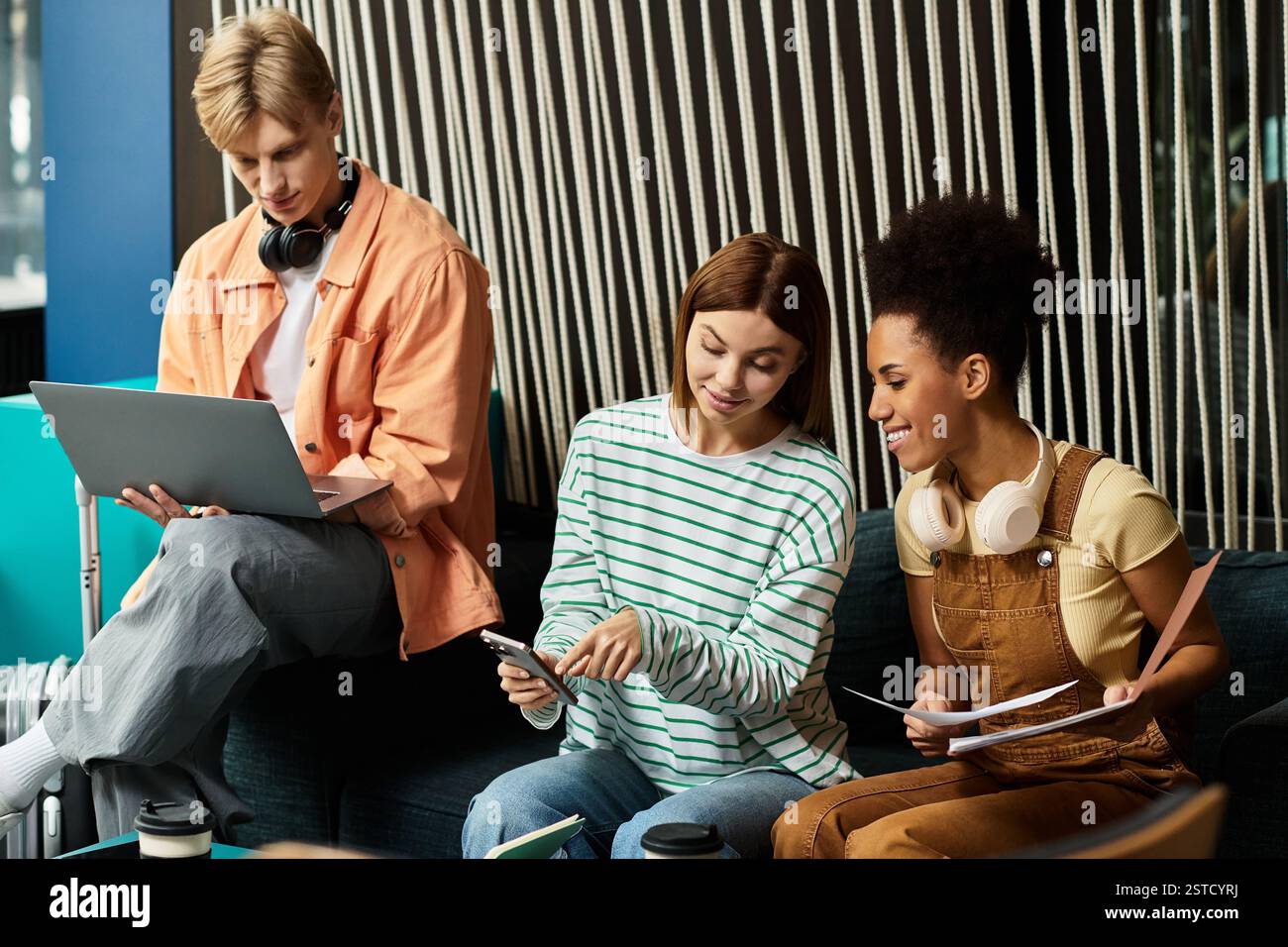 Three colleagues engaged in a lively discussion while sharing ideas in ...
