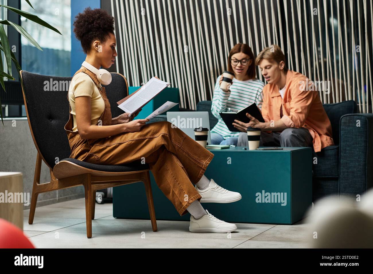 Team members engage in discussions while reviewing documents and ...