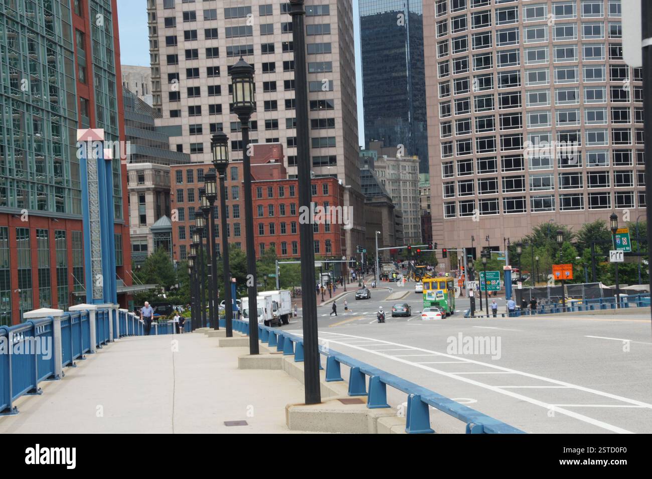 Boston street scene. Traffic on busy road lined with tall buildings ...