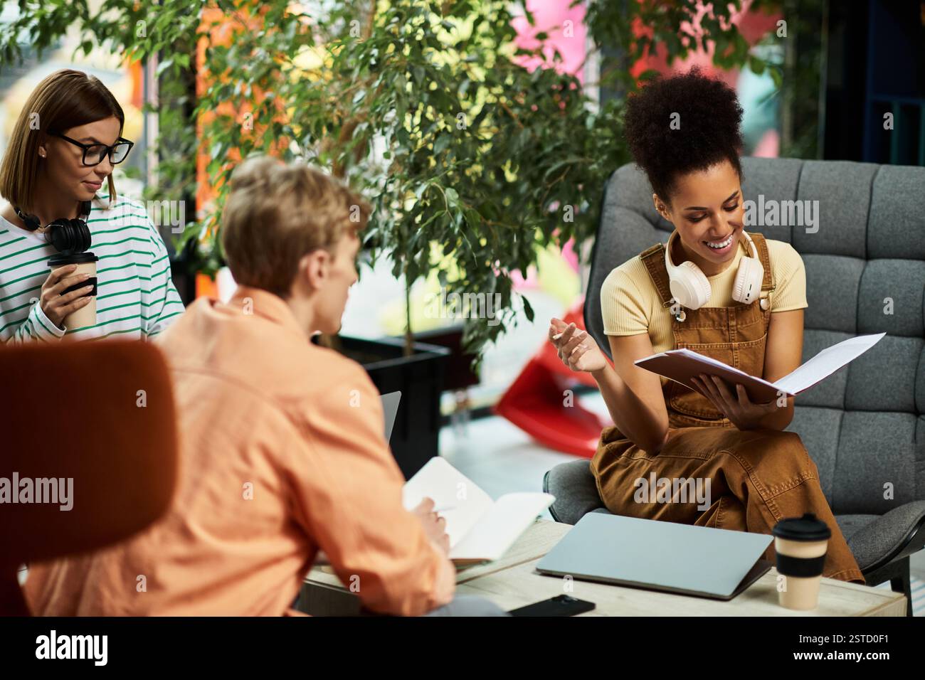 A group of colleagues collaborates in a lively hotel environment ...