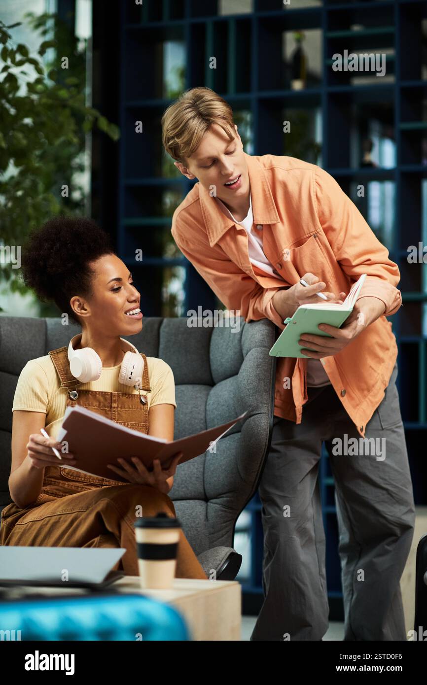 Two colleagues engage in a lively discussion while reviewing notes in a ...