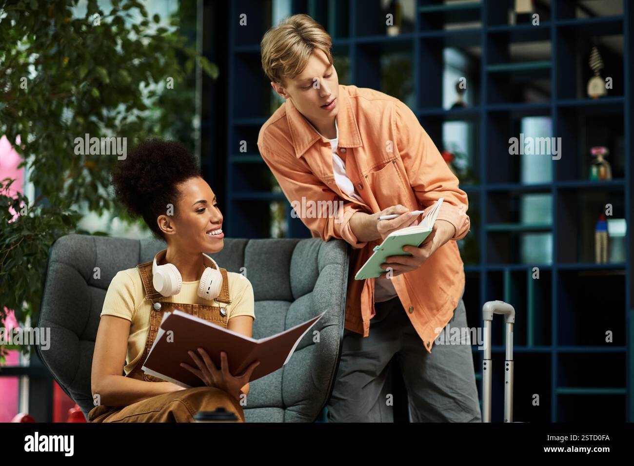 Two colleagues engaged in a productive discussion while relaxing in a ...