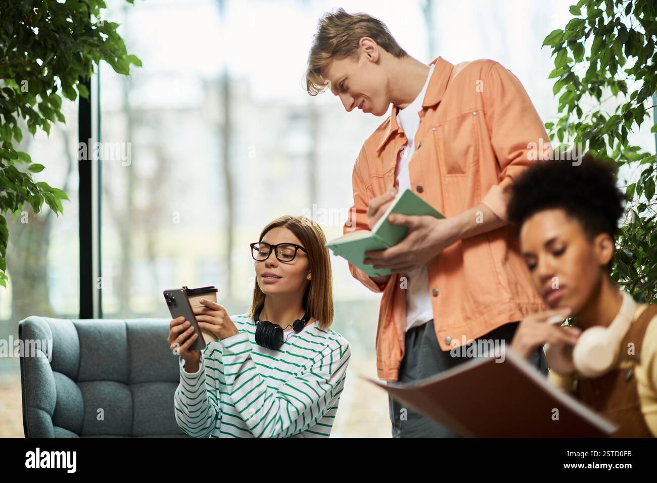 A group of colleagues engages in collaborative tasks in a hotel lounge ...