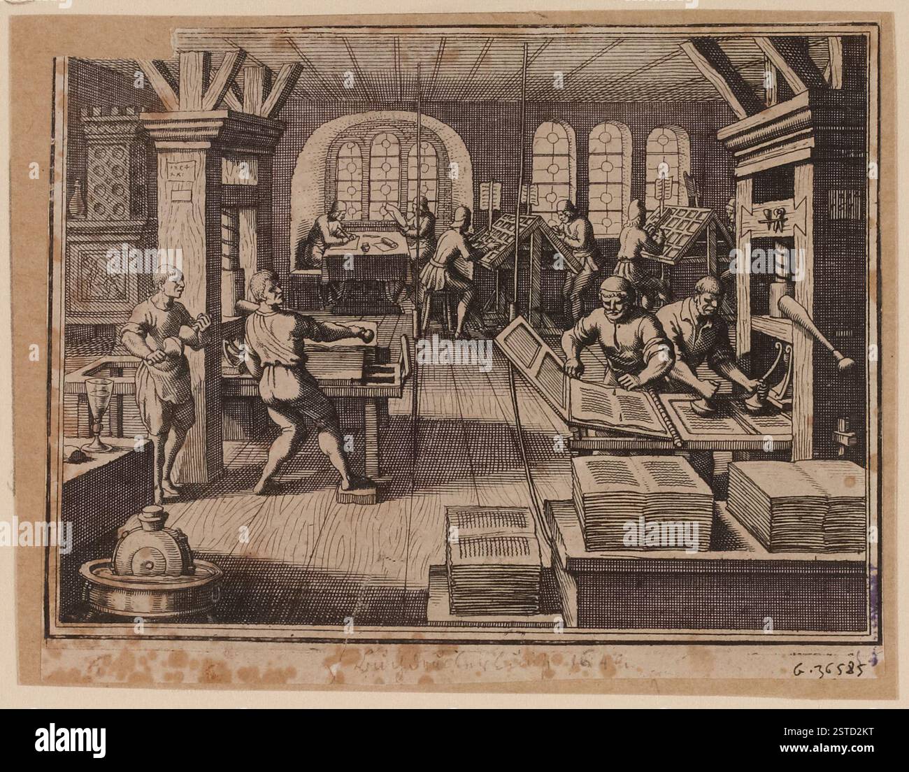 Print workers are engaged in their tasks in a printer workshop, using ...