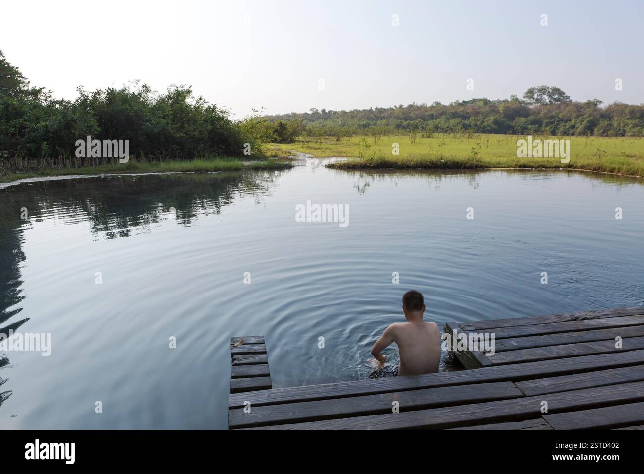Myanmar, a man enjoying the hot springs at the Bayin Nyi Cave and hot ...