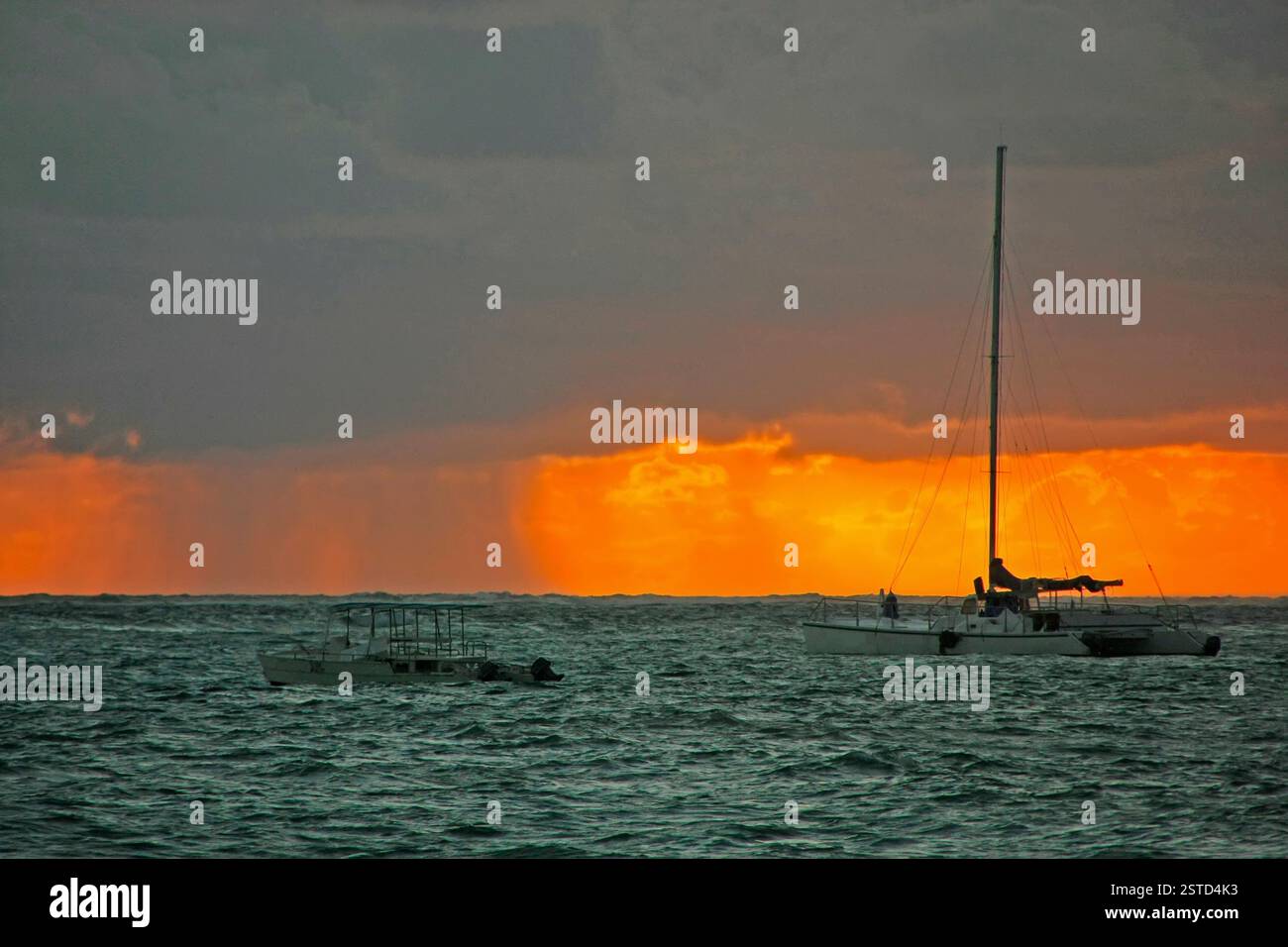 Rainstorm in a sea at sunrise Stock Photo - Alamy