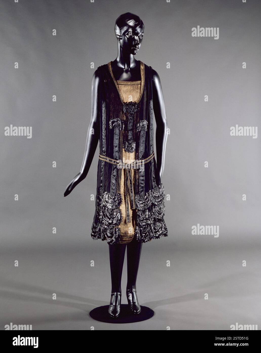 A dress featuring intricate rosette designs, adding texture and visual ...