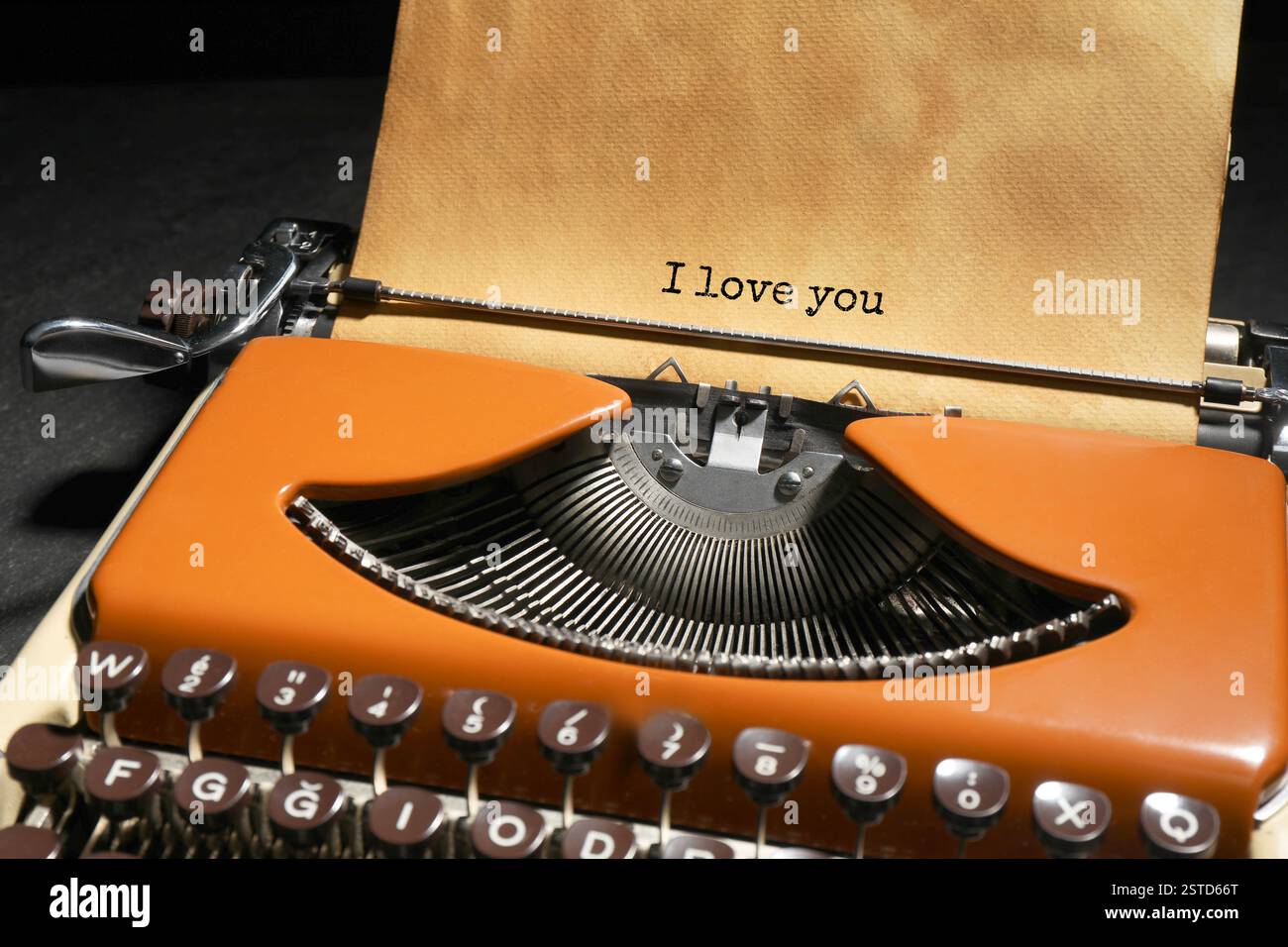 Typewriter with sheet of paper on table, closeup. Typed text I Love You ...