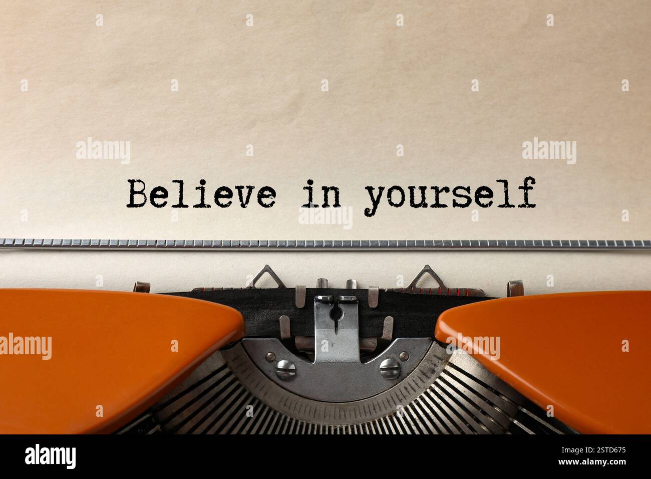 Typewriter with sheet of paper, closeup. Typed text Believe In Yourself ...