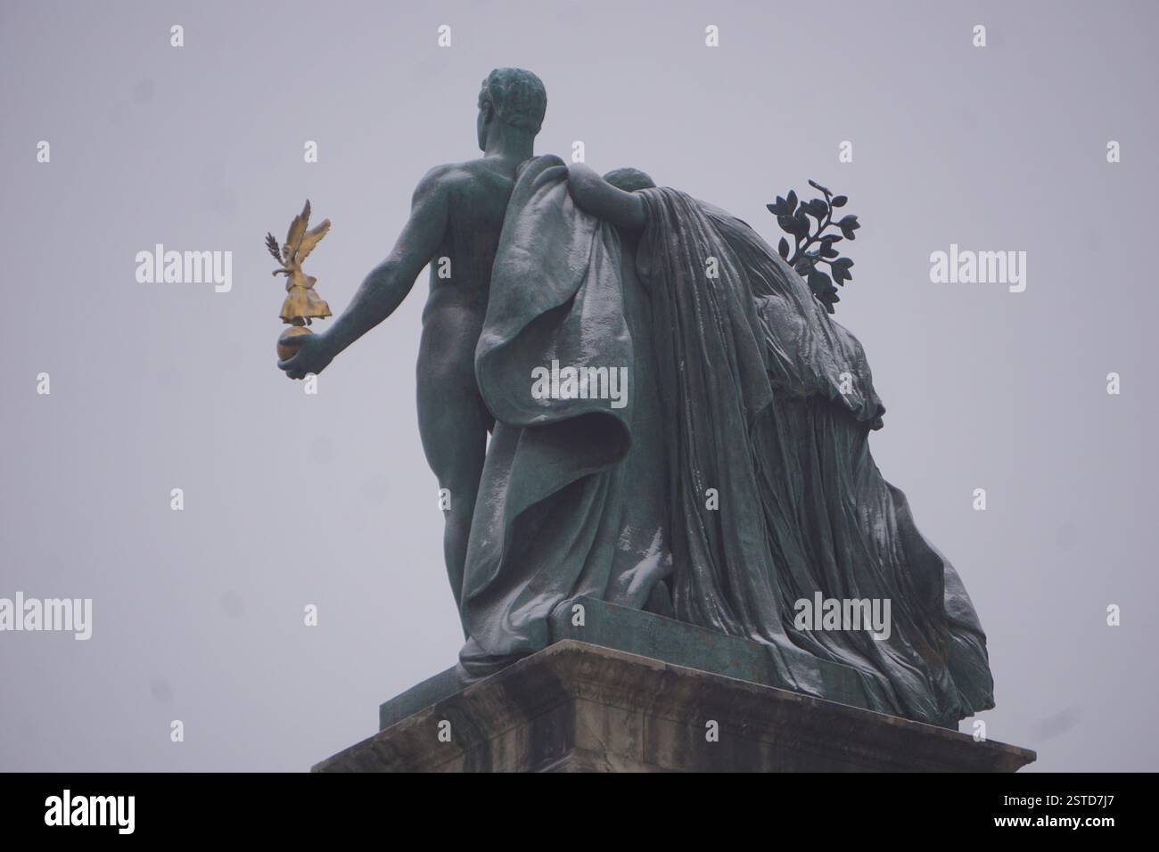 Back view of two historic bronze statues symbolizing knowledge and ...