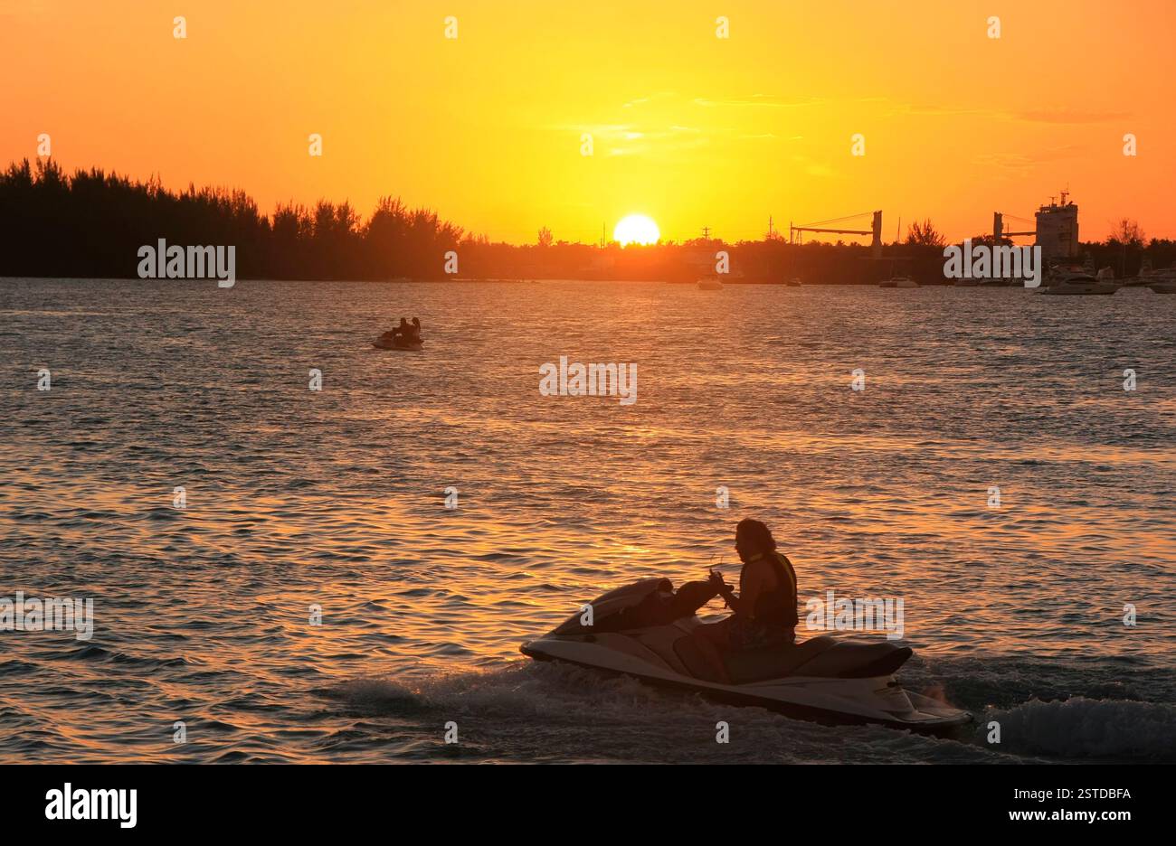 Silhouette of waterbike at sunset, Boca Chica bay Stock Photo - Alamy
