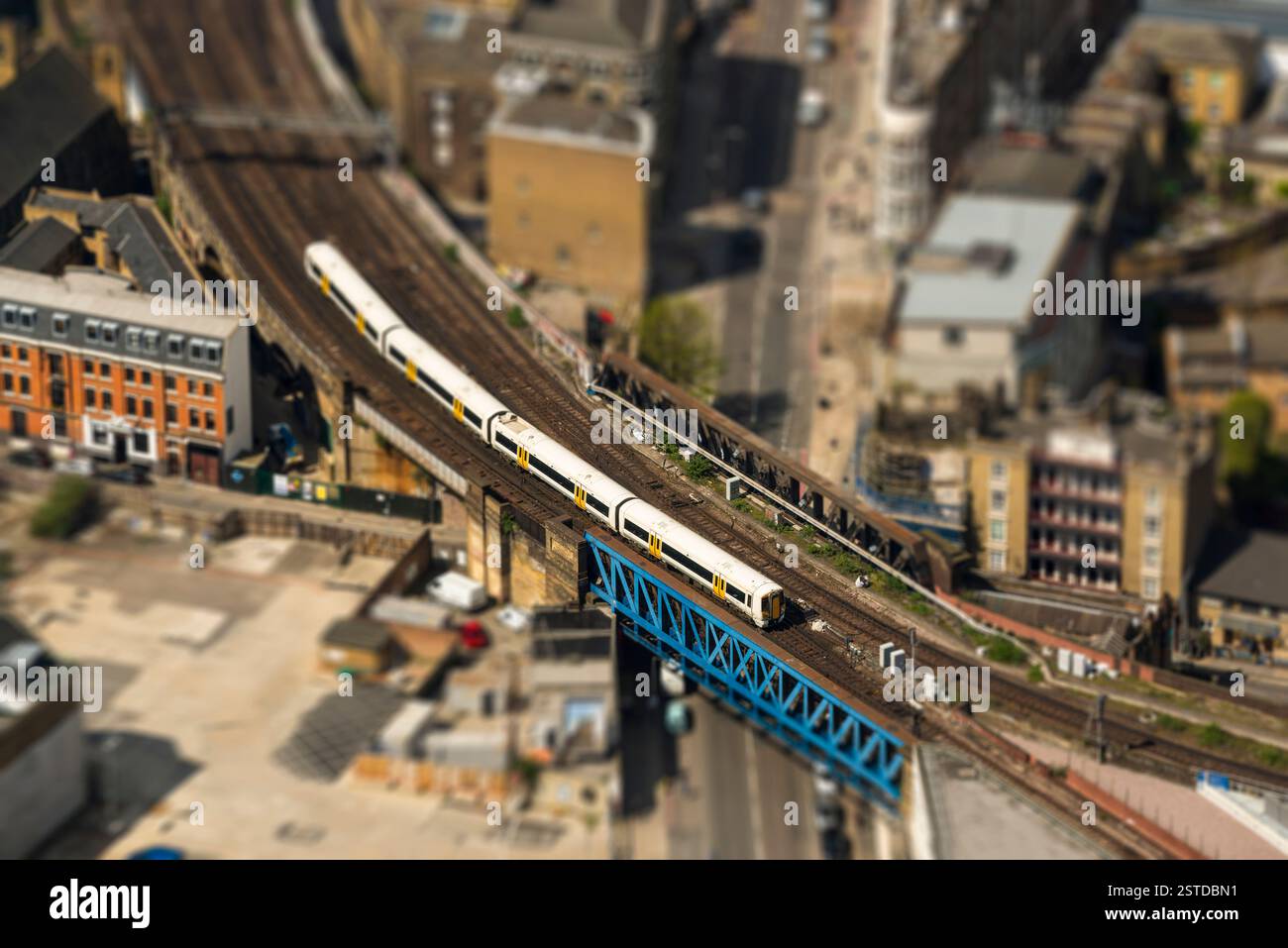 Train on a bridge in London, tilt-shift effect Stock Photo - Alamy