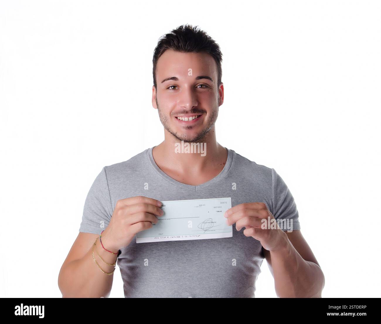 Smiling young man with check in his hands Stock Photo - Alamy