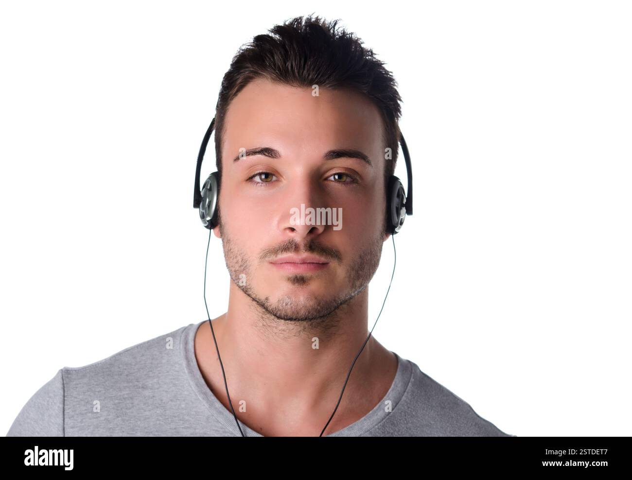Good looking young man listening to music with headphones Stock Photo ...