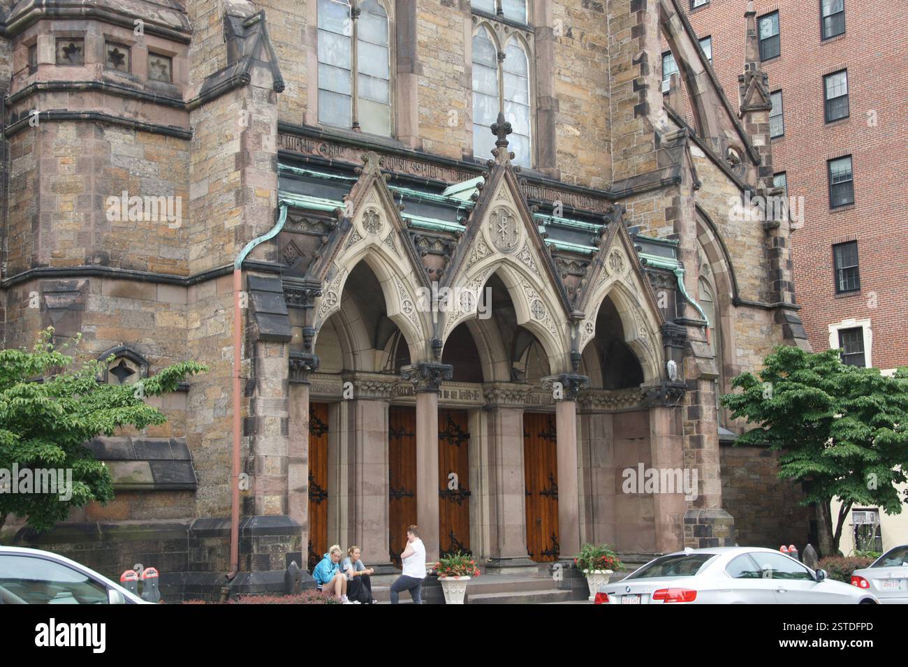 Church Boston. Stone exterior with ornate arched entryway and wooden ...