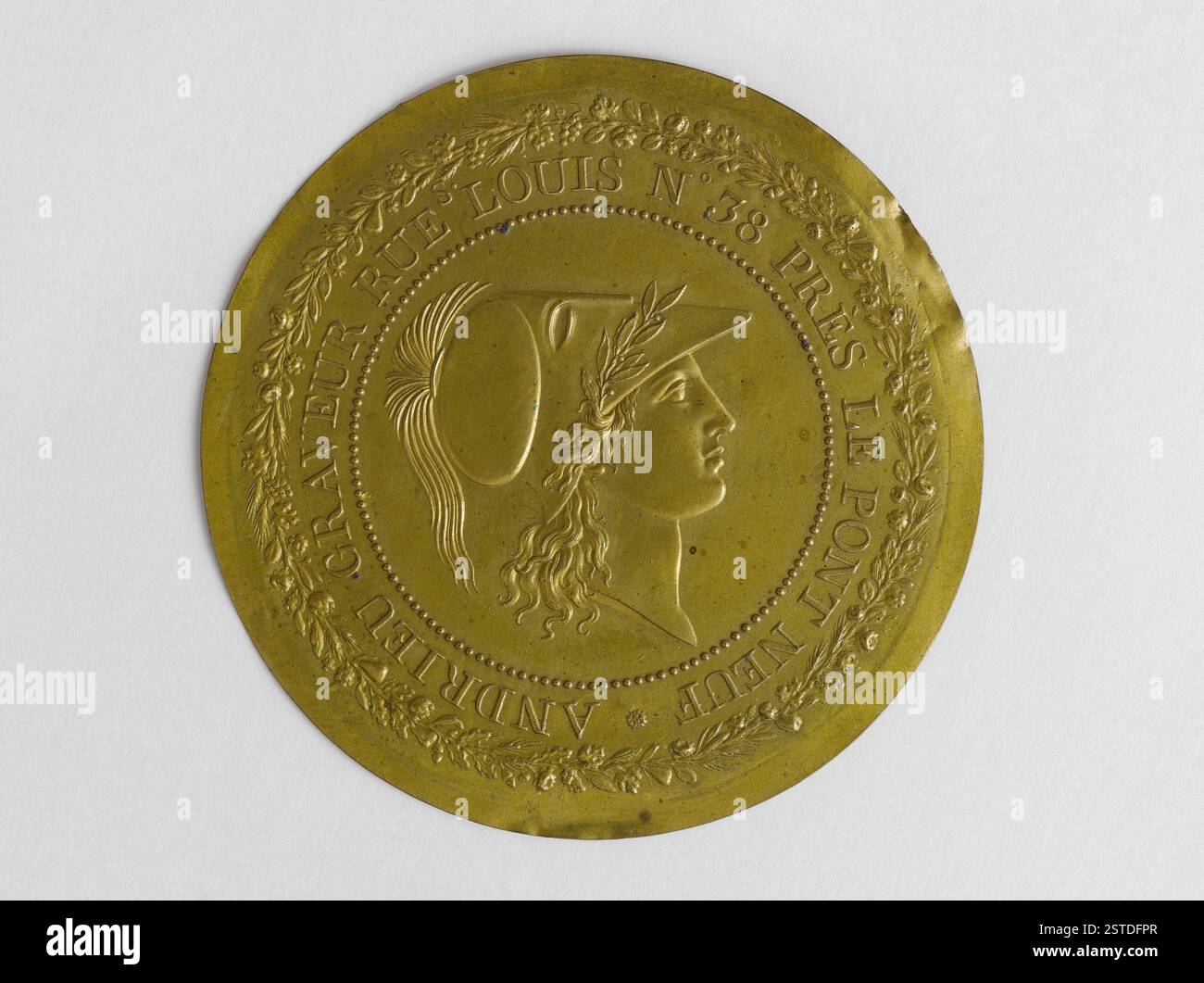 A right-facing bust of Minerva, the Roman goddess of wisdom, surrounded ...