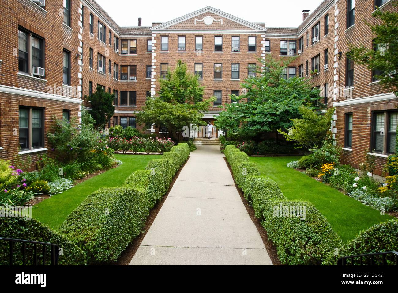 Courtyard. Boston. Lush green lawn with manicured hedges and colorful ...
