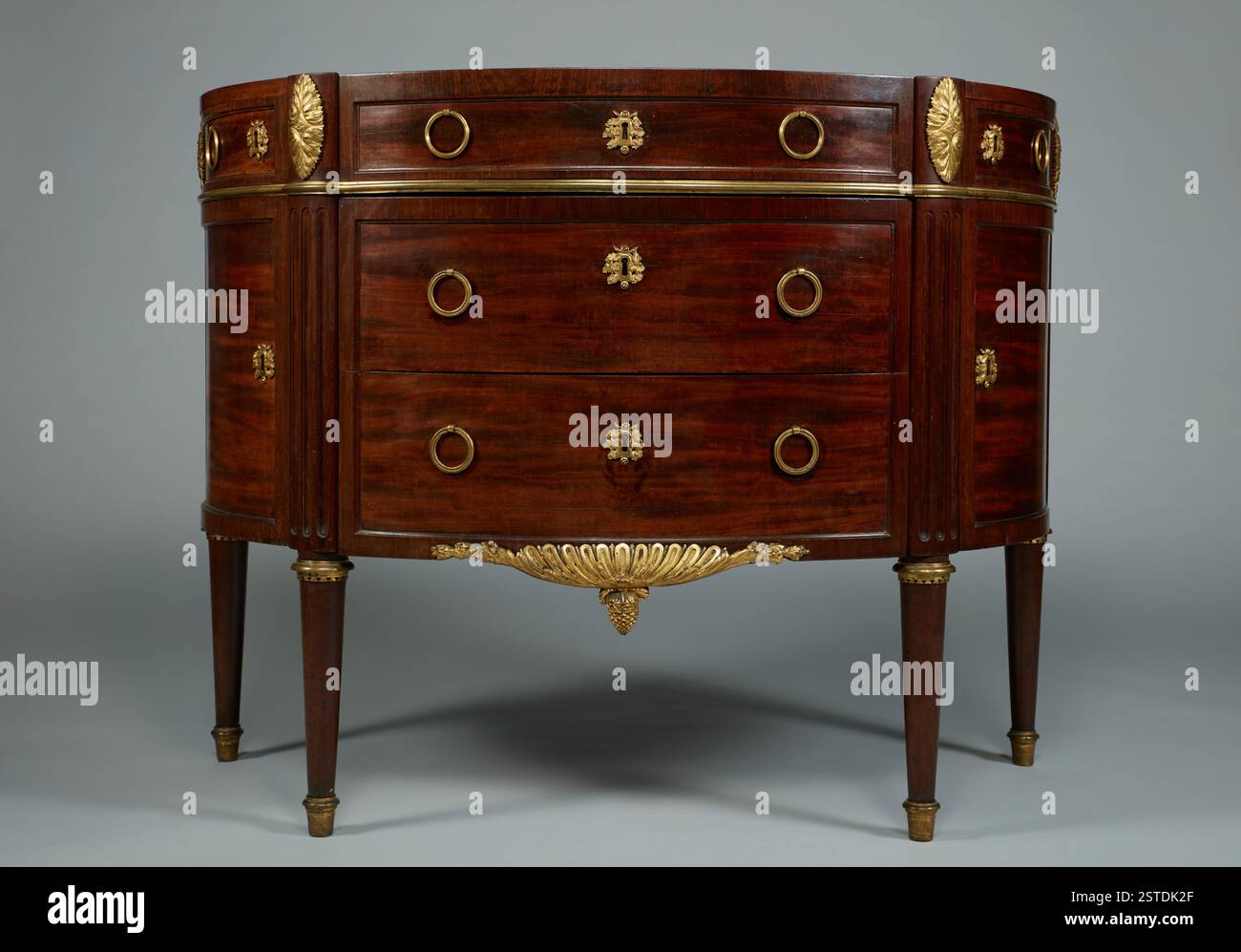 A detailed view of antique furniture, featuring fluted tapered feet ...