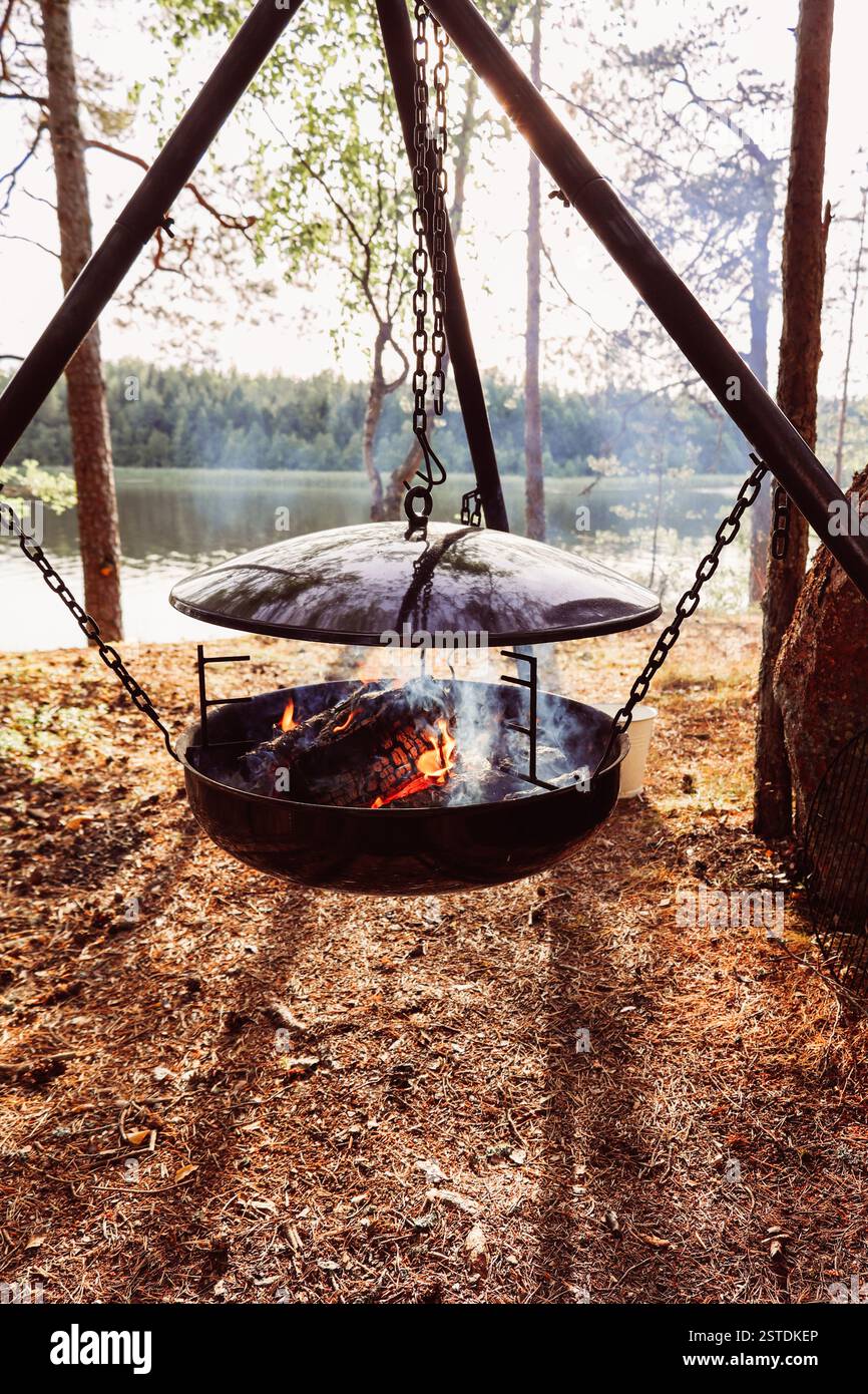 Traditional Finnish wilderness camp with a log fire. Perfect moment ...