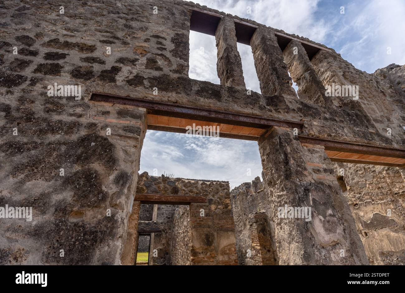 Pompei, Italy - May 25, 2024: Framing supports holding up the ruins of ...
