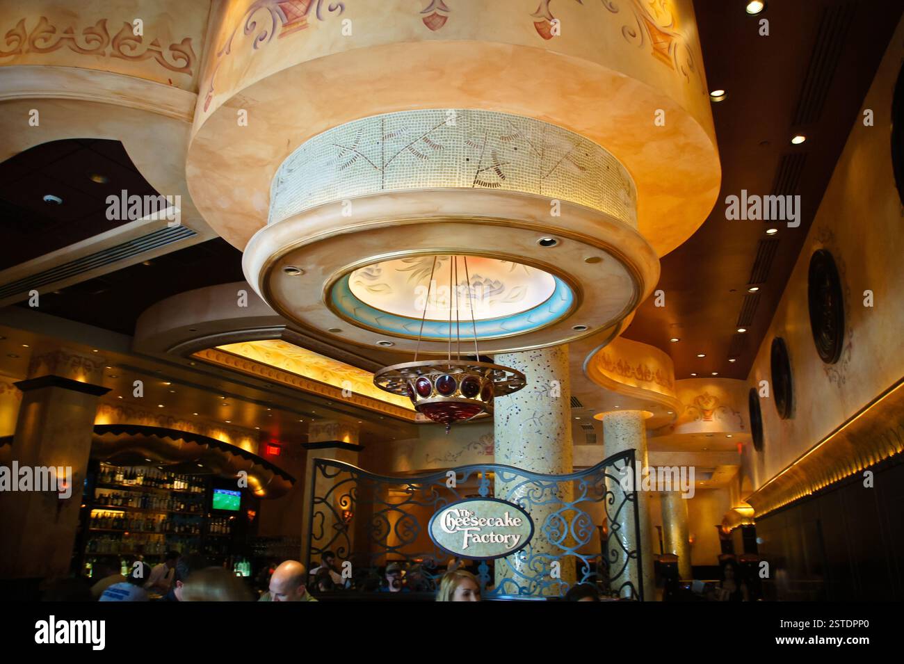 The Cheesecake Factory in Boston. Warm lighting and ornate decor create ...