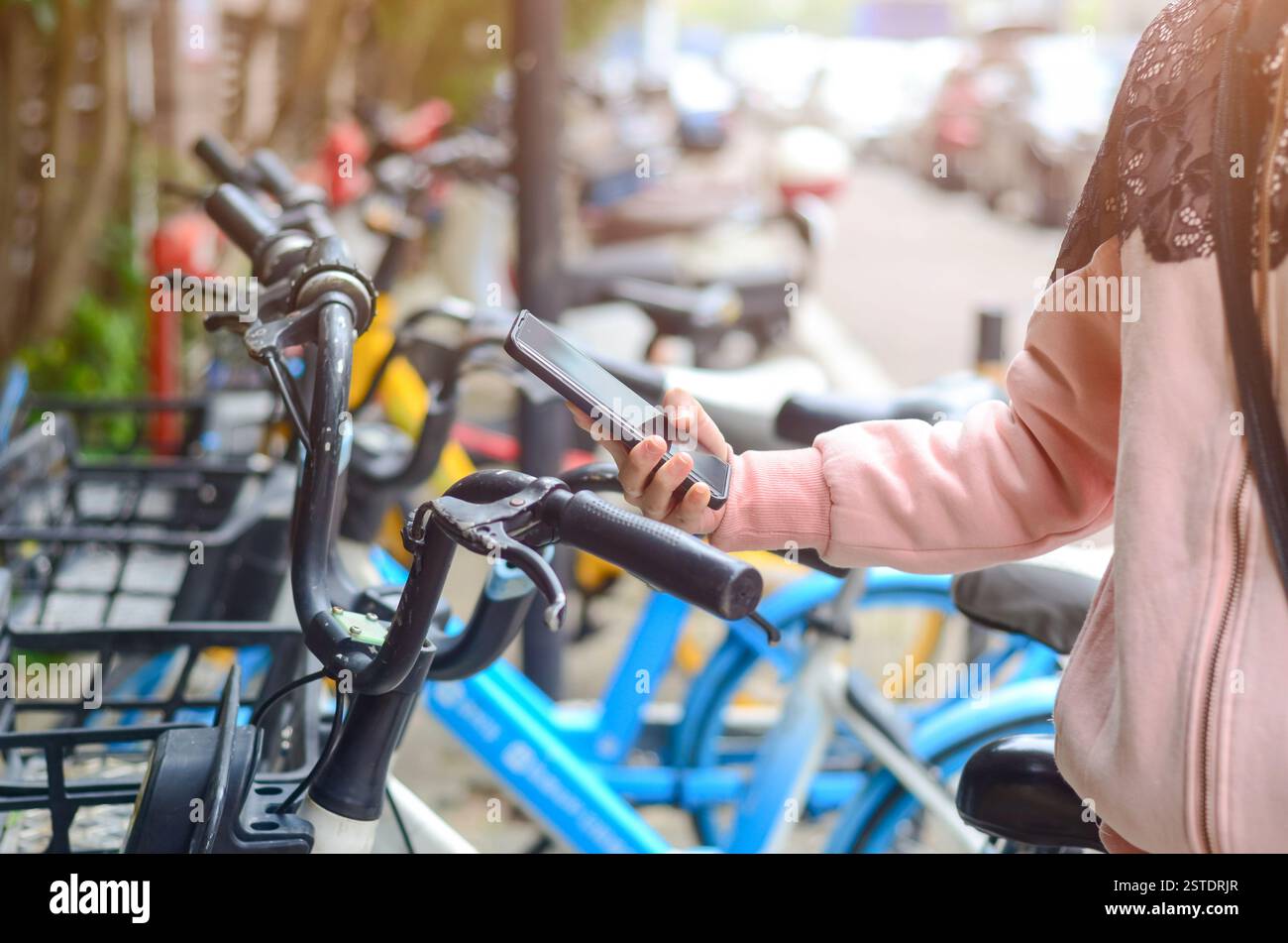 People use smart phone to scan the QR code on a shared bike to unlock ...