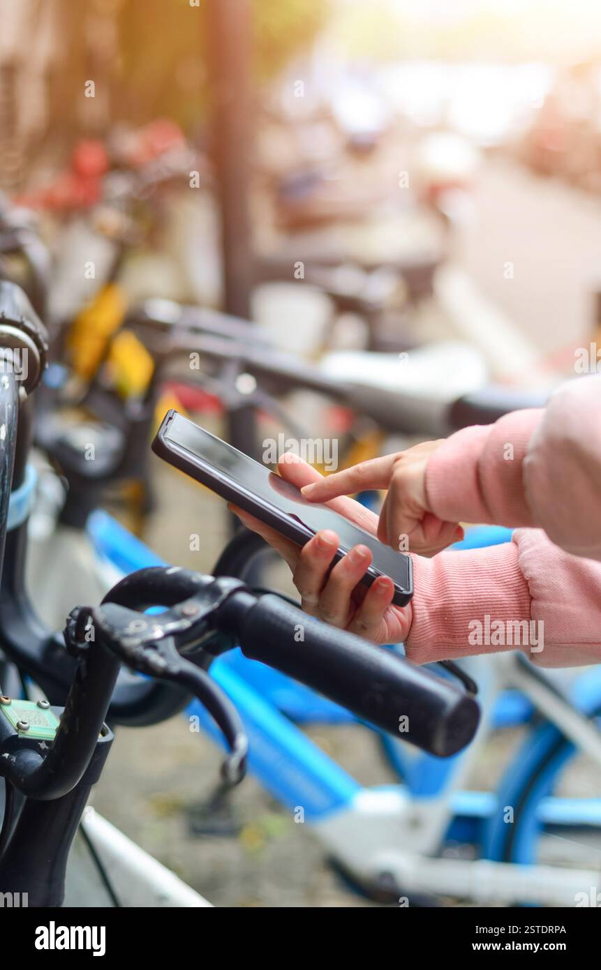 People use smart phone to scan the QR code on a shared bike to unlock ...