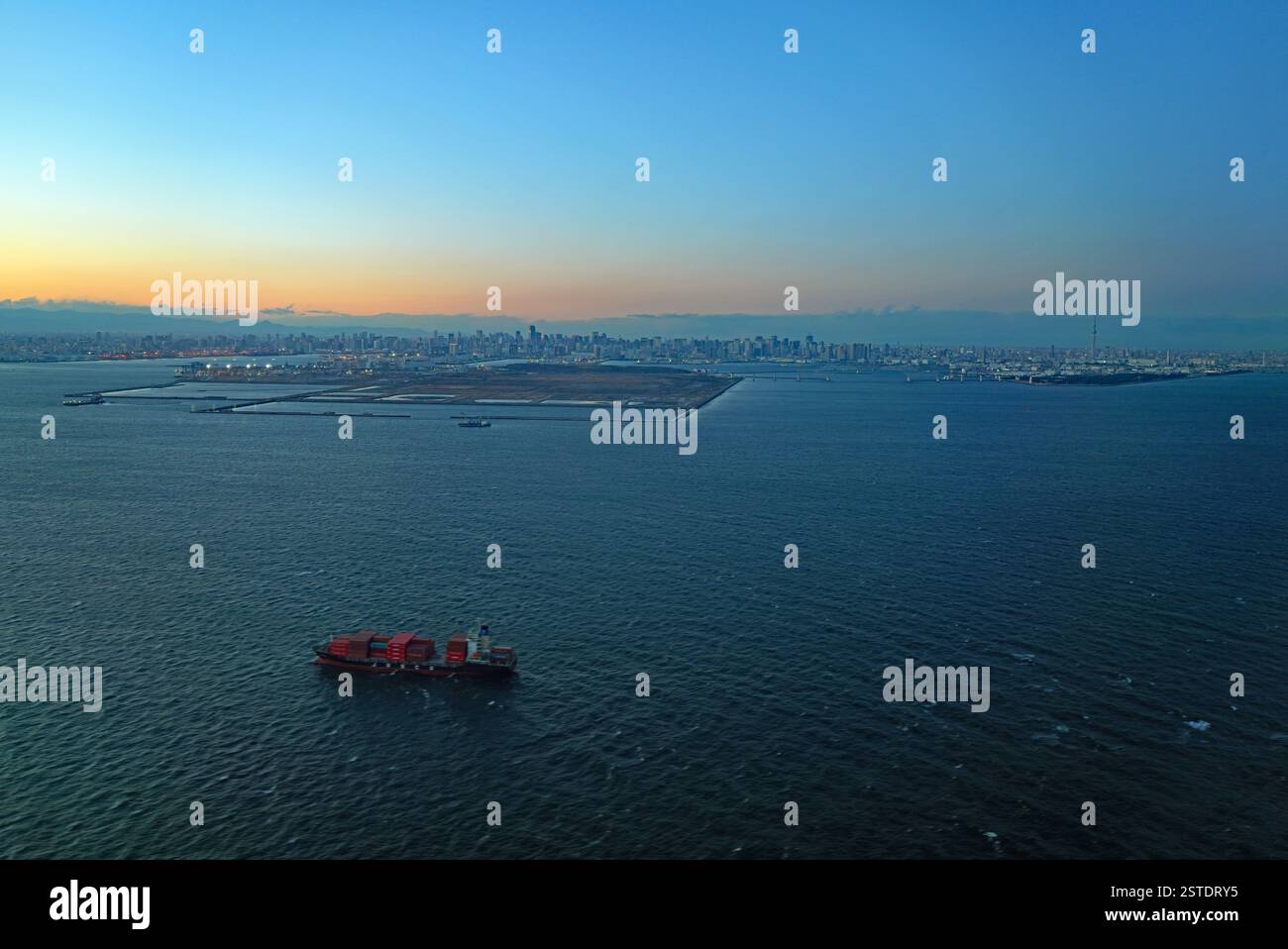 Aerial view of the Tokyo Bay, Japan, at nightfall in approach at Haneda ...