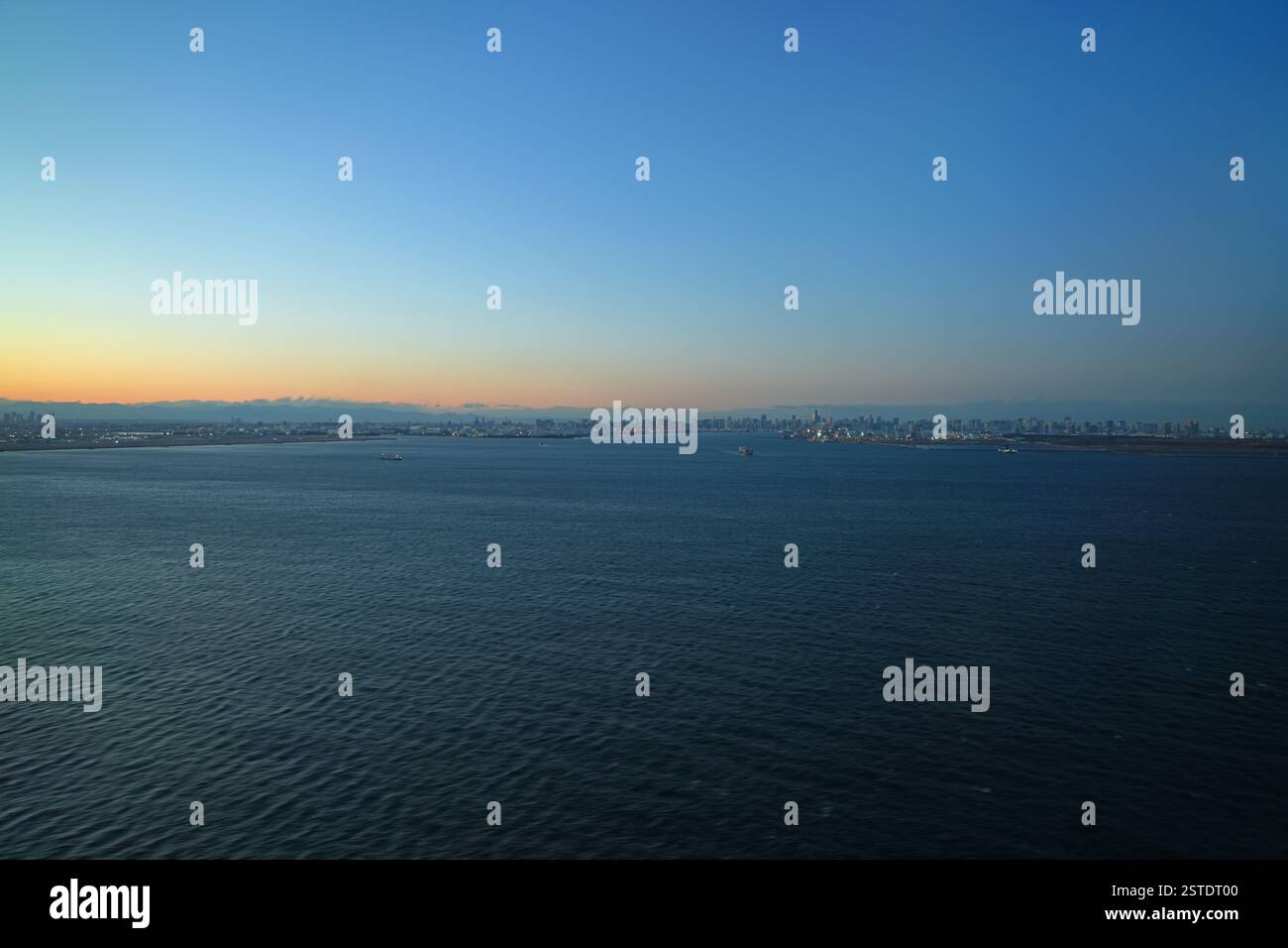 Aerial view of the Tokyo Bay, Japan, at nightfall in approach at Haneda ...