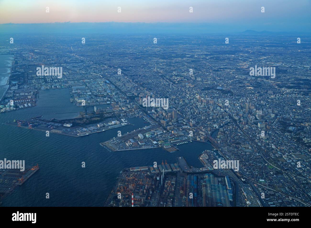 Aerial view of the Tokyo Bay, Japan, at nightfall in approach at Haneda ...
