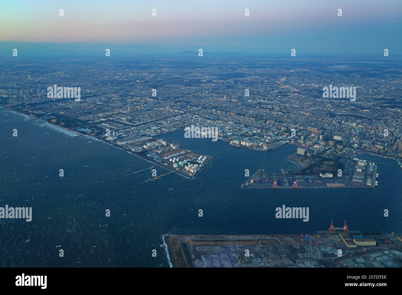 Aerial view of the Tokyo Bay, Japan, at nightfall in approach at Haneda ...