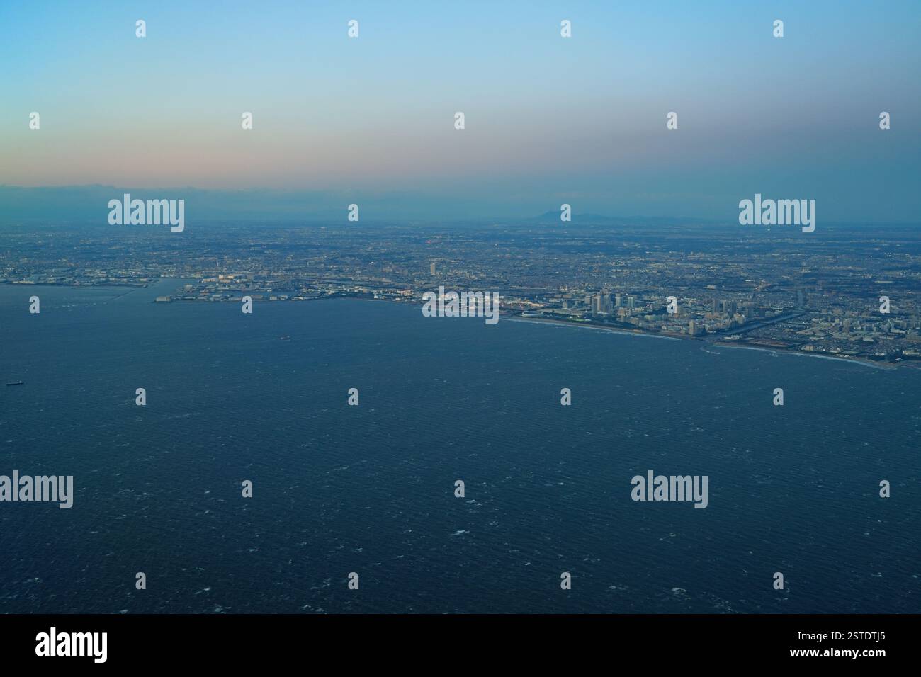 Aerial view of the Tokyo Bay, Japan, at nightfall in approach at Haneda ...