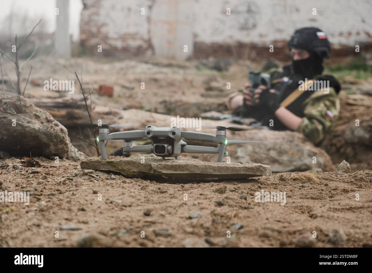 UAV operator with a remote control sitting in a trench. The concept of ...