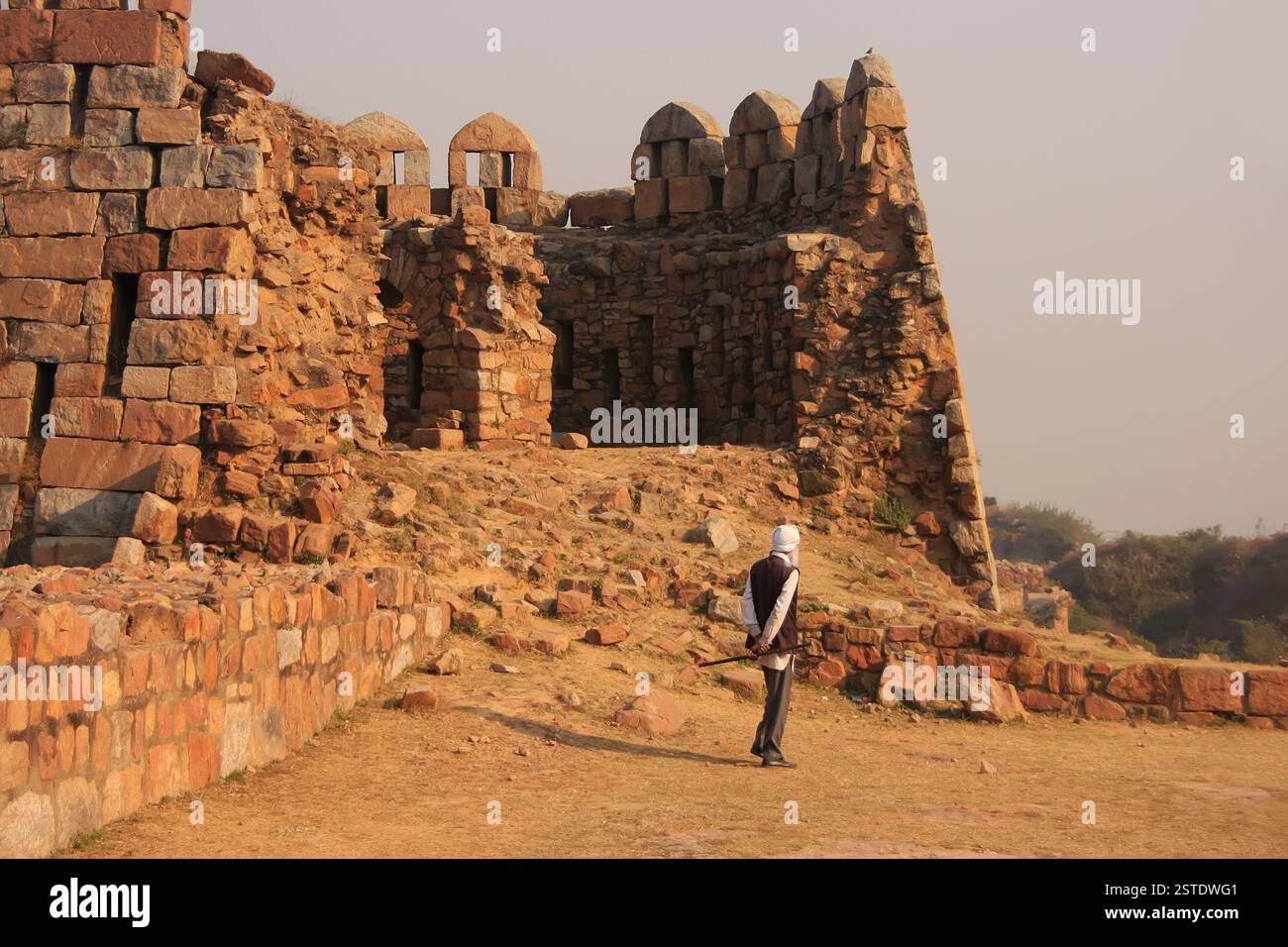 Local guard walking around Tughlaqabad Fort, New D Stock Photo - Alamy