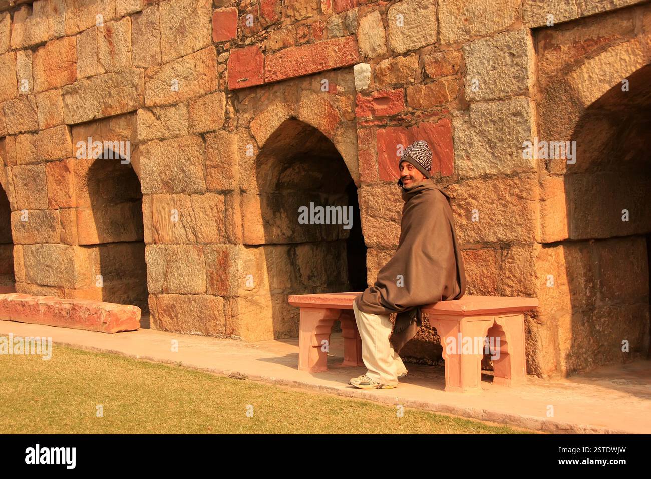 Indian man sitting on a bench at Mausoleum of Ghiy Stock Photo - Alamy