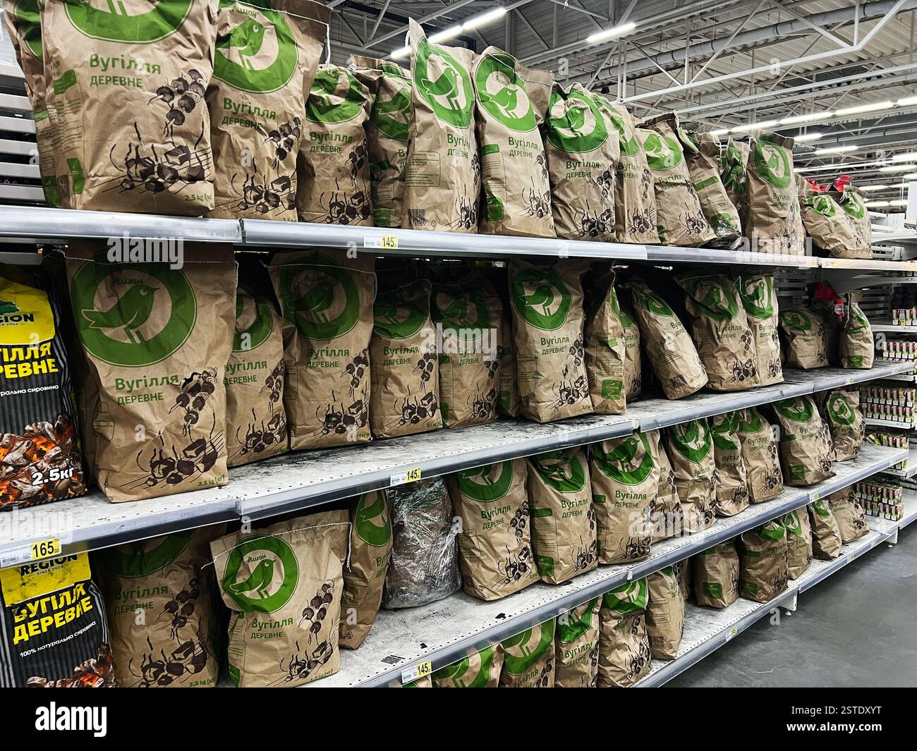 Lviv, Ukraine - February 16, 2025: A display of charcoal bags on metal ...