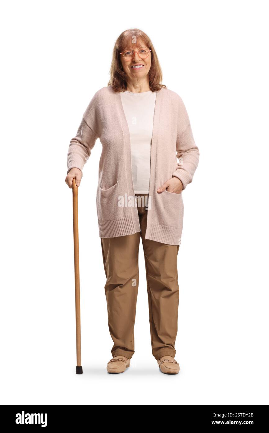 Mature woman standing with a walking cane isolated on white background ...