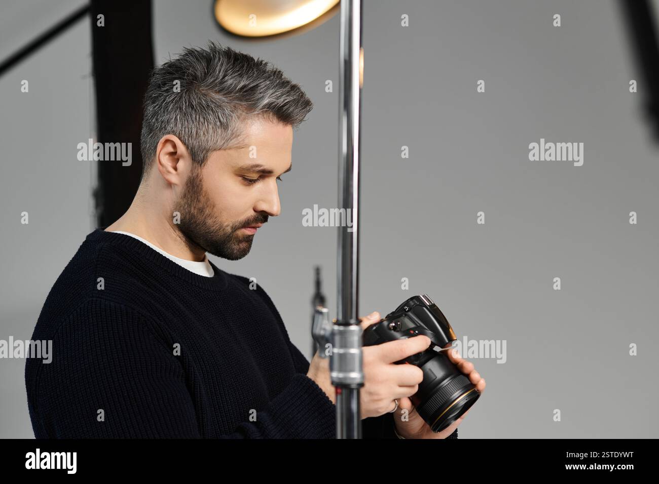 Skilled individual examines camera gear while getting ready for an ...