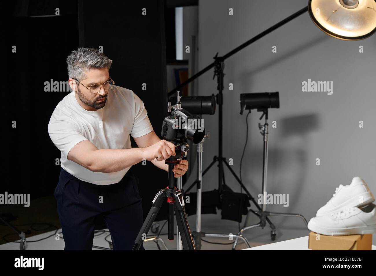 Skilled individual adjusting camera settings for a fashion shoot ...