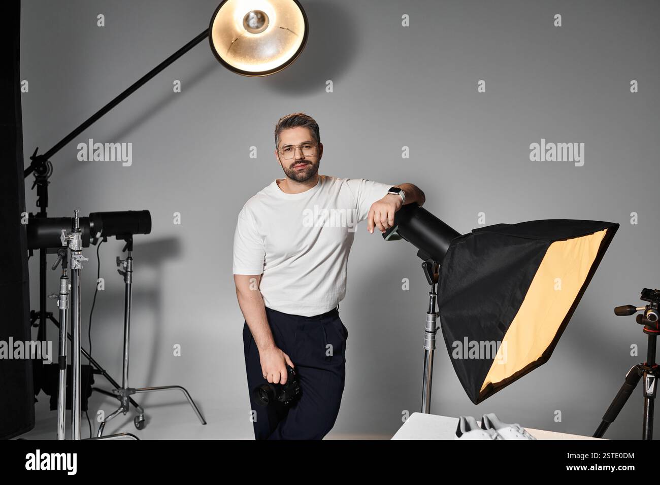 A talented individual stands confidently in a studio, ready to capture ...