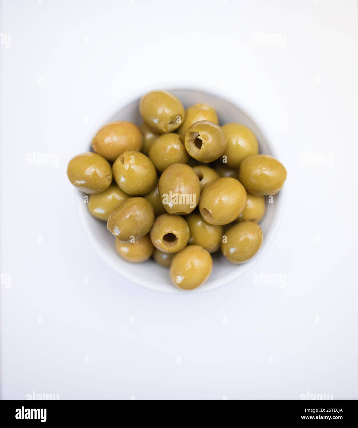 three green olives isolated on white Stock Photo - Alamy
