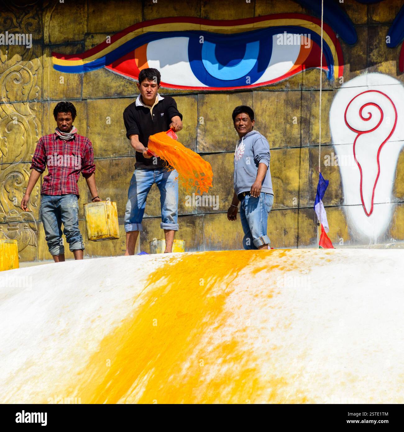 KATHMANDU, NEPAL - JANUARY 27, 2014: A man throws orange paint on ...
