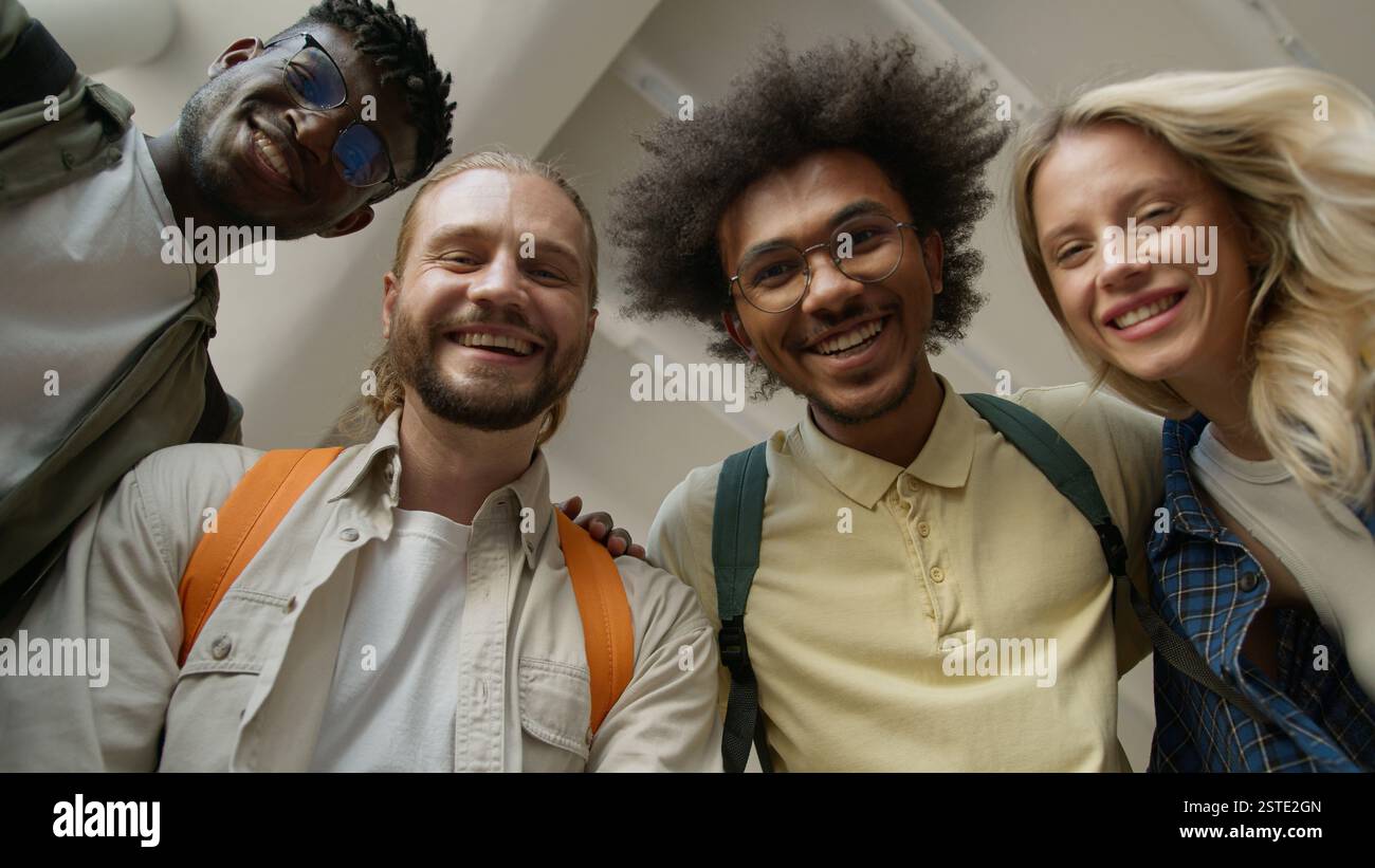 Bottom view university college four students happy excited winners ...