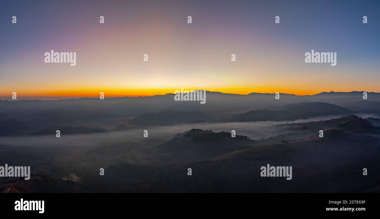 Aerial View of An image of sweet sky in sunrise above a valley of mist ...